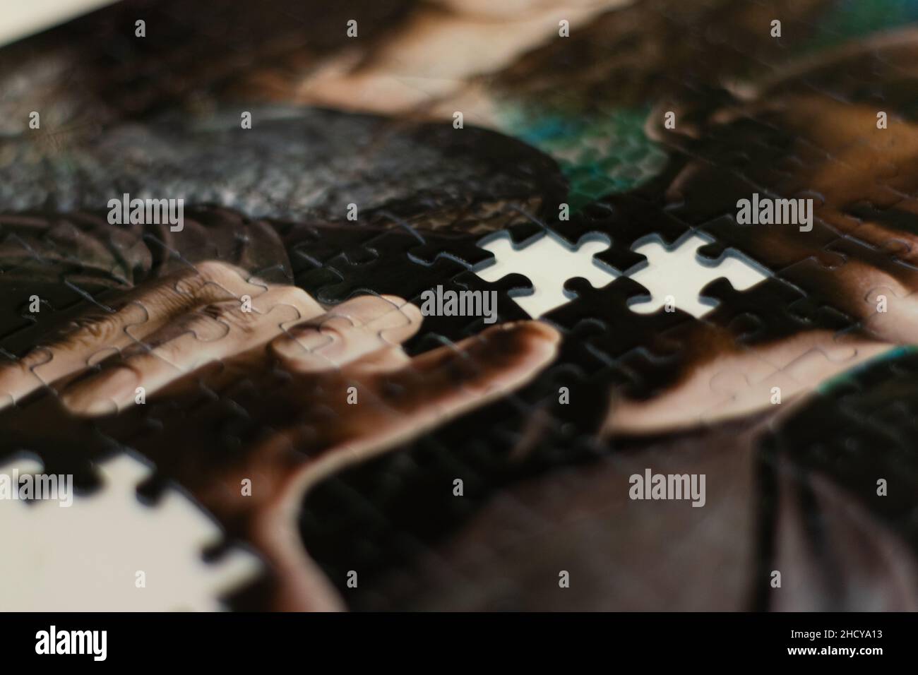 Assembling a puzzle, hands on puzzles, puzzle missing pieces ...