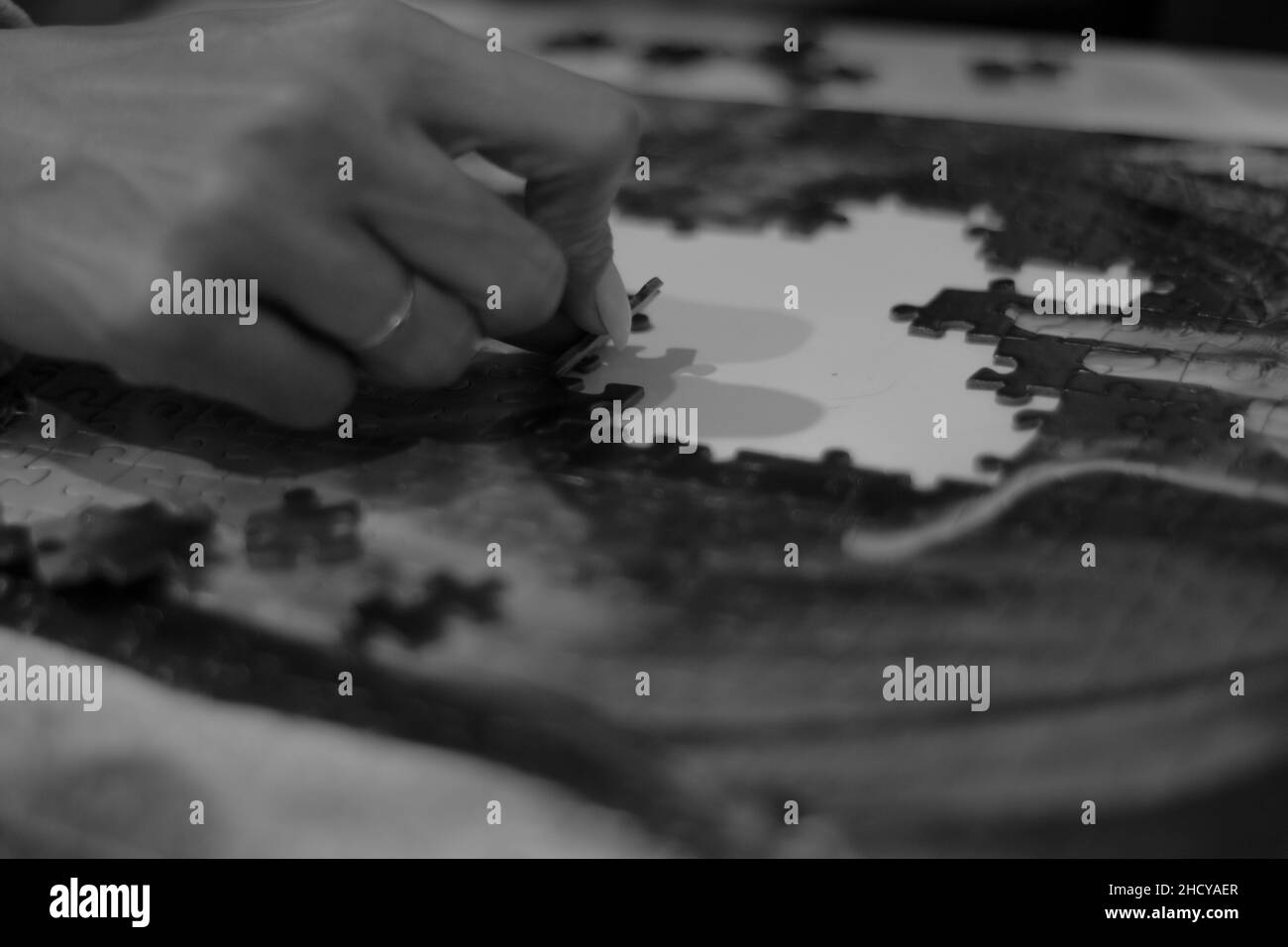 Assembling a puzzle, hands on puzzles, puzzle missing pieces ...