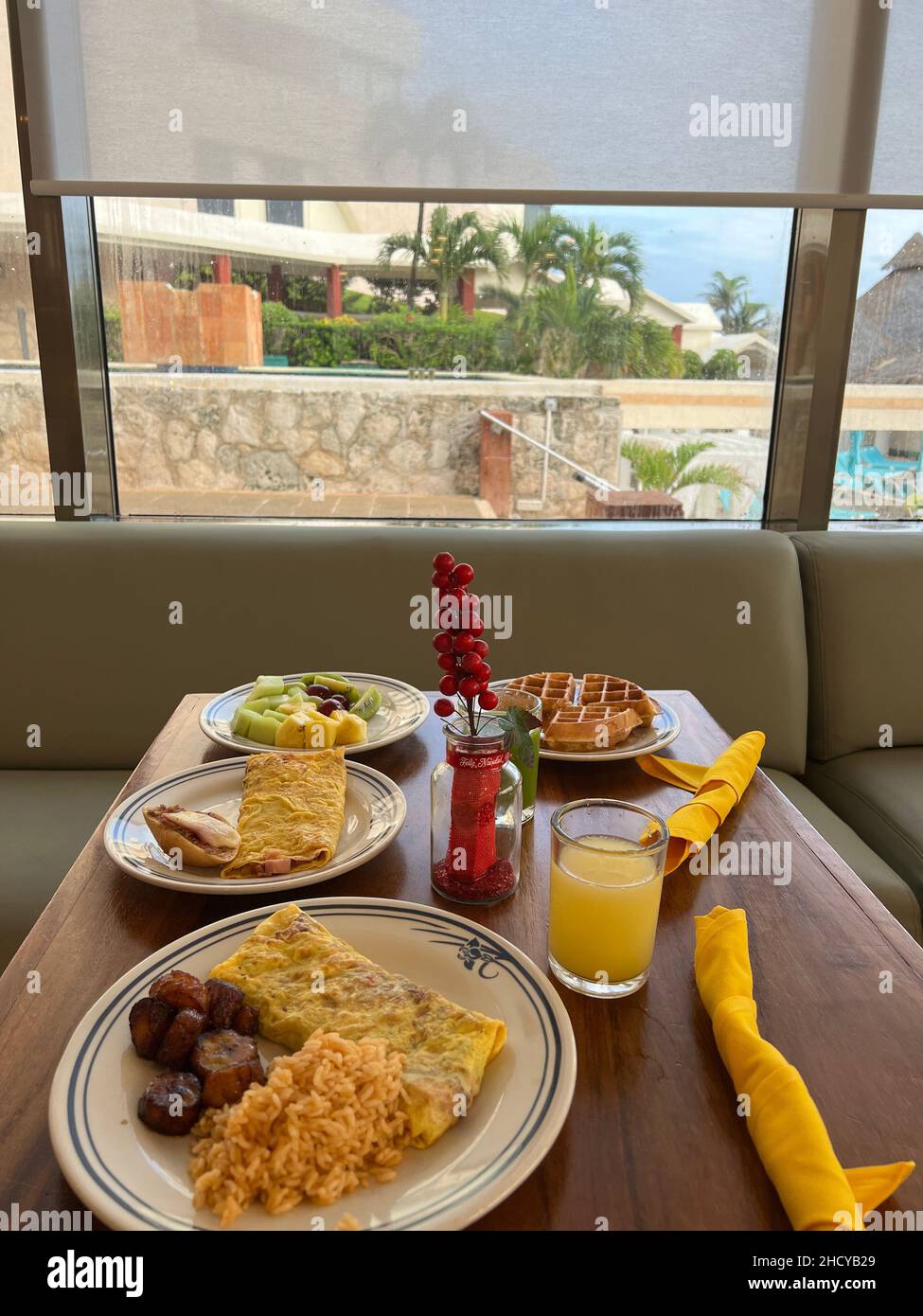 American breakfast on a table in a restaurant with view on pools and ...