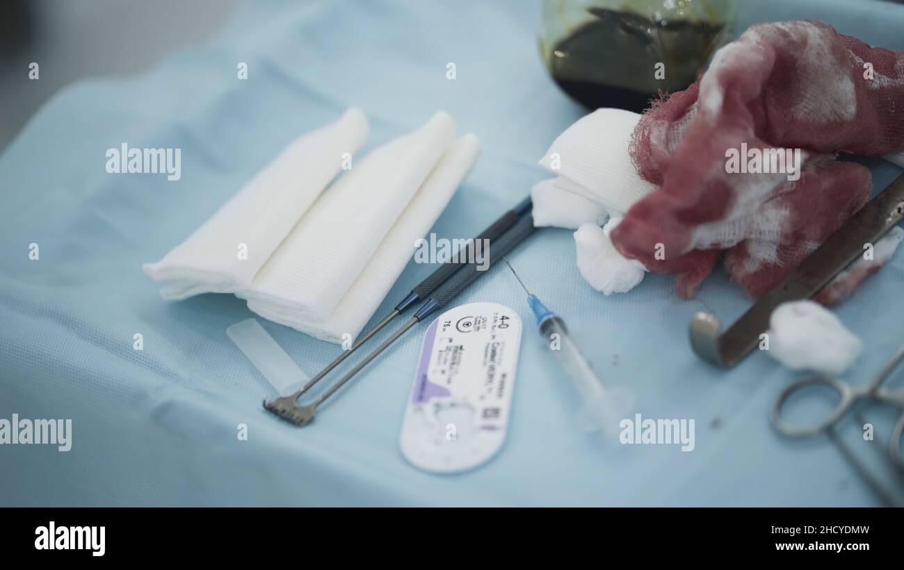 Surgical instruments and bloody bandages. Action. Close-up of surgical ...