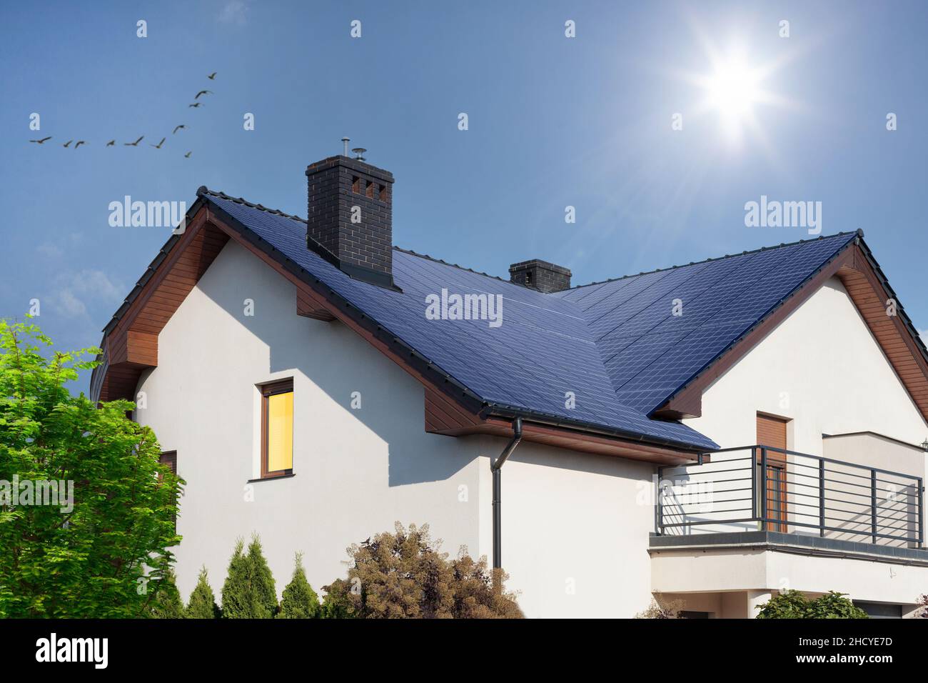 Modern house with solar panels. Rays of suns and clear sky. Beautiful ...