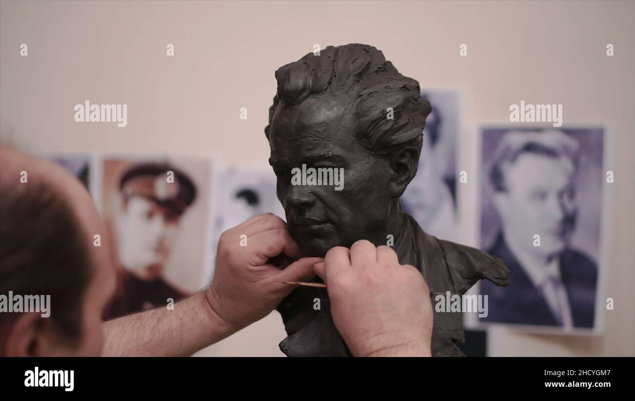 Sculptor created a figure of a man. Clip. Man creates his own hands the ...