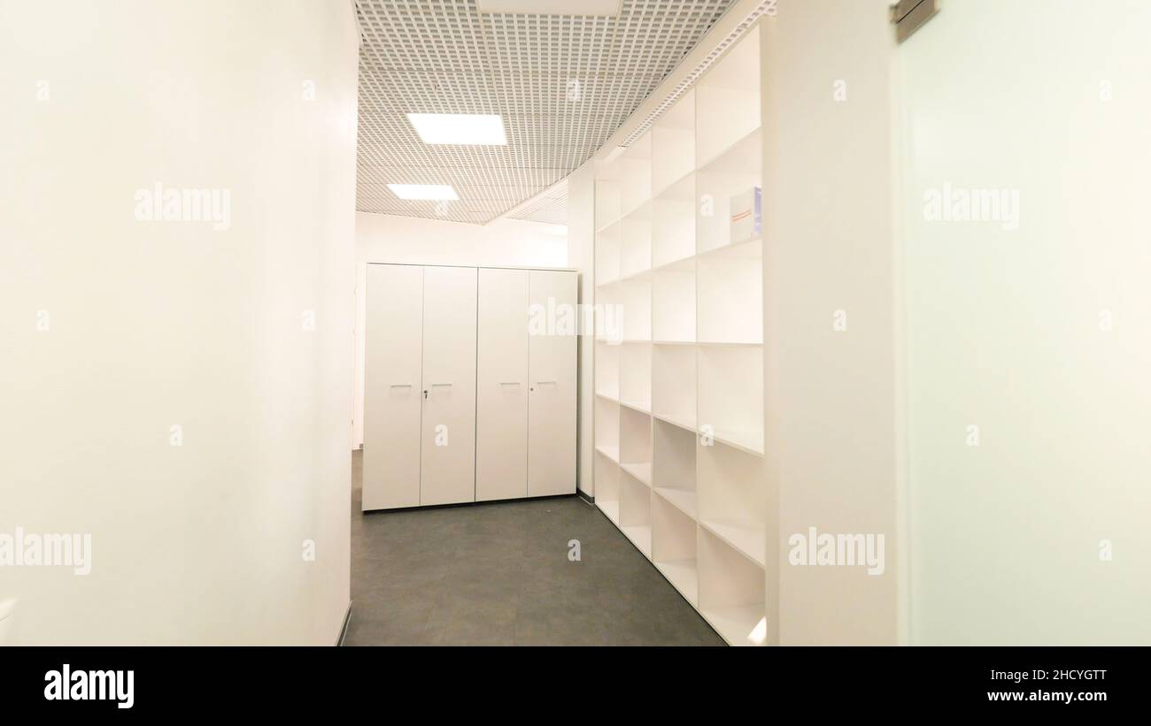Long, arcuate office hallway and a reception desk. Corridor of a public ...