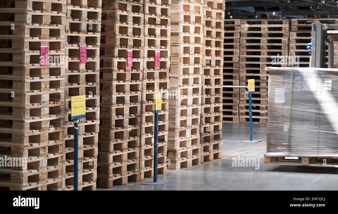 Warehouse with racks and shelves, filled with cardboard boxes, wrapped ...