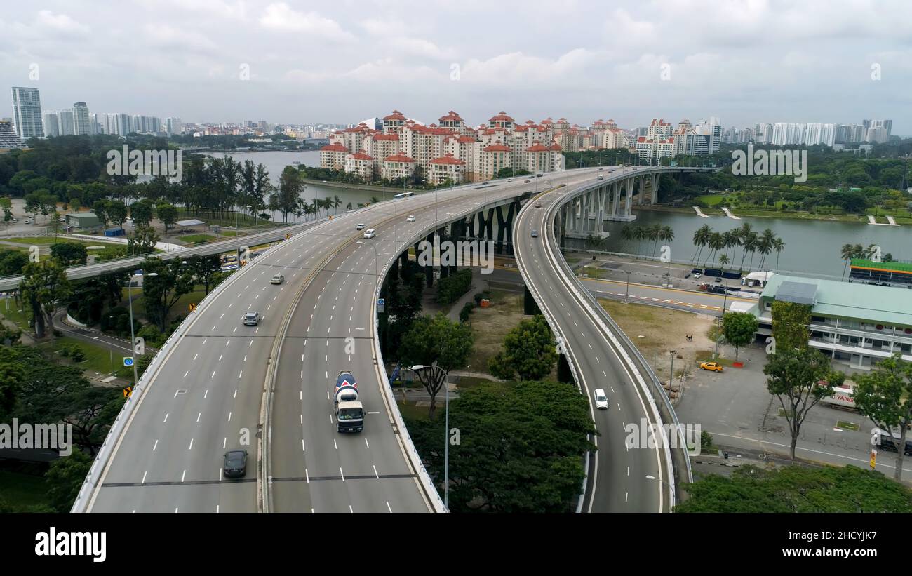 Panoramic aerial view of river bridge in the city with trees in parks ...