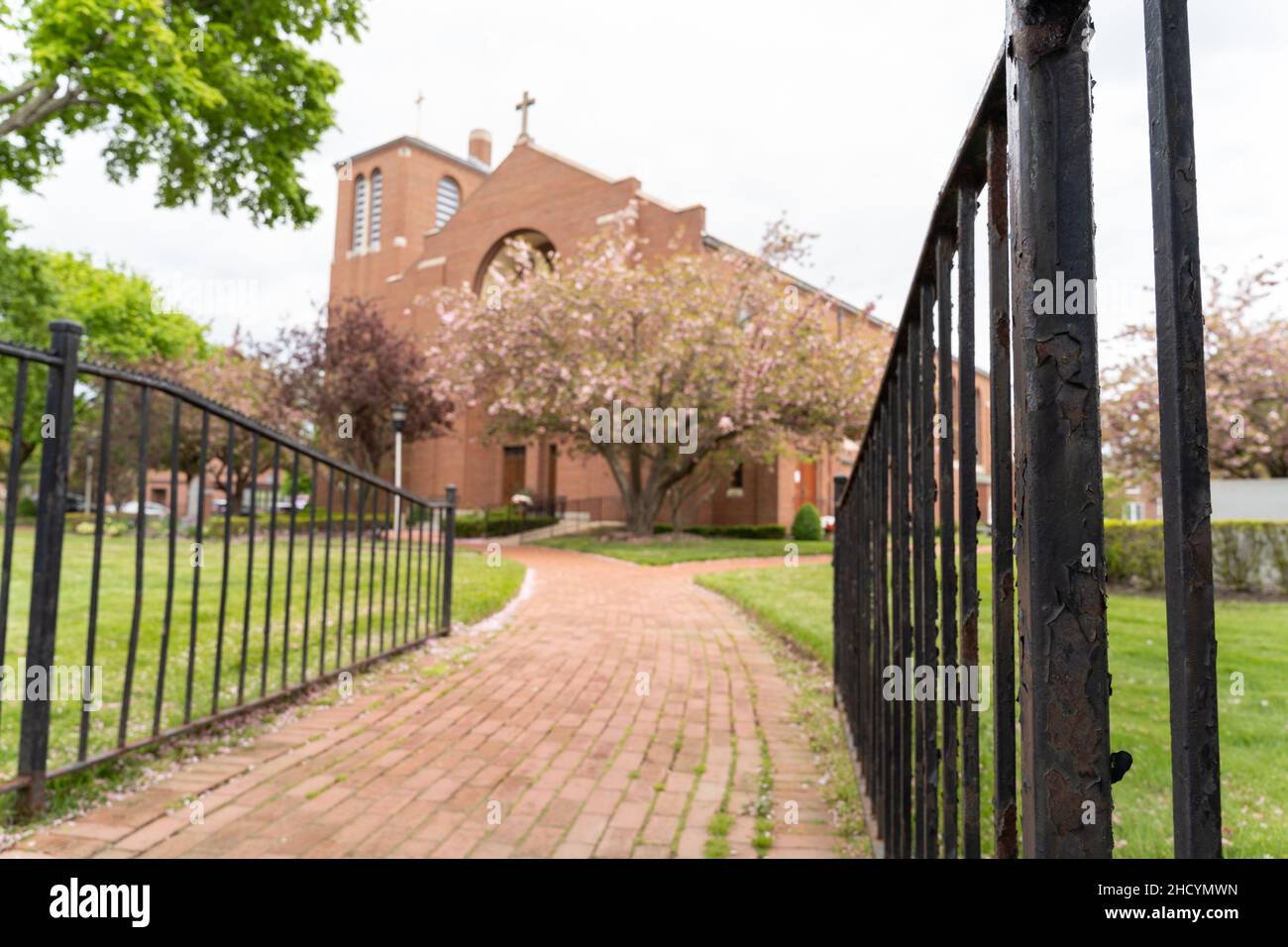 A generic church viewed through steel fence posts along beautiful ...