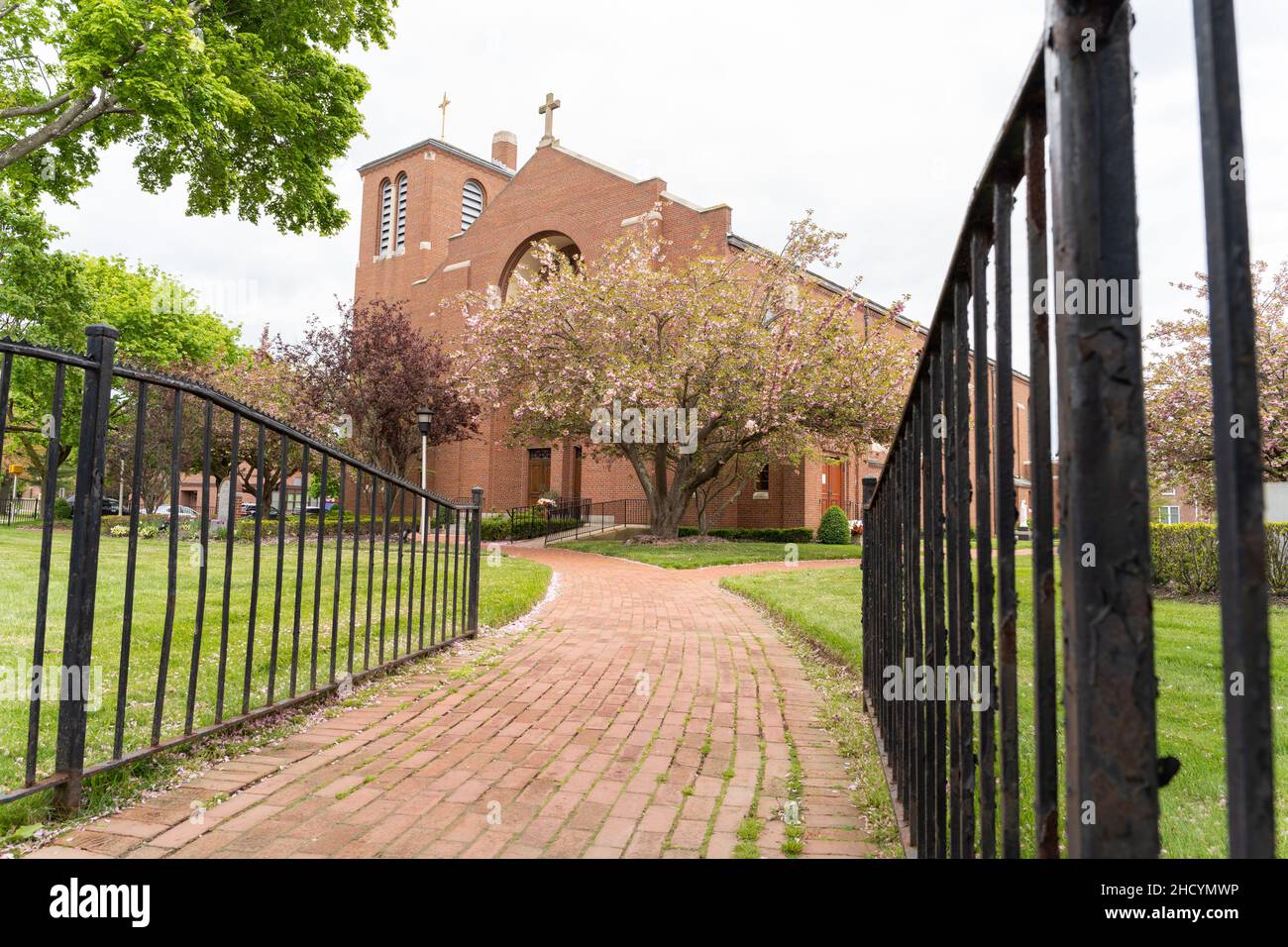 A generic church viewed through steel fence posts along beautiful ...