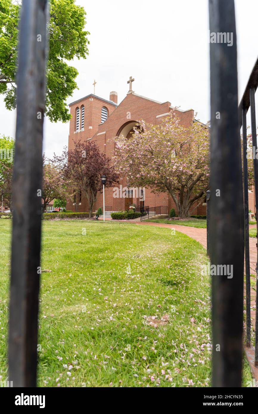 A generic church viewed through steel fence posts along beautiful ...