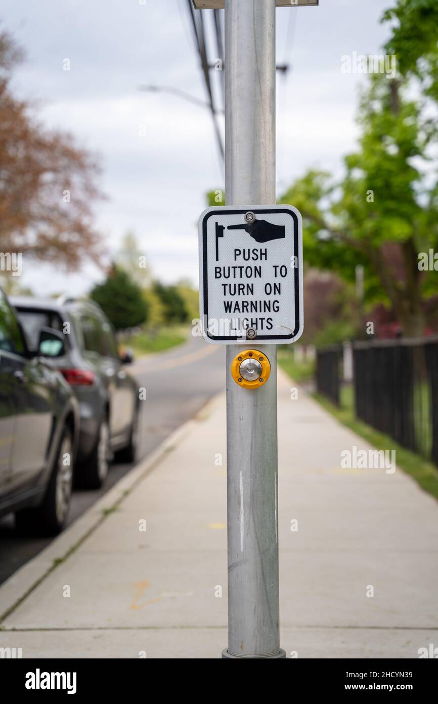 Crosswalk signal button posted outside on utility pole to safely cross ...