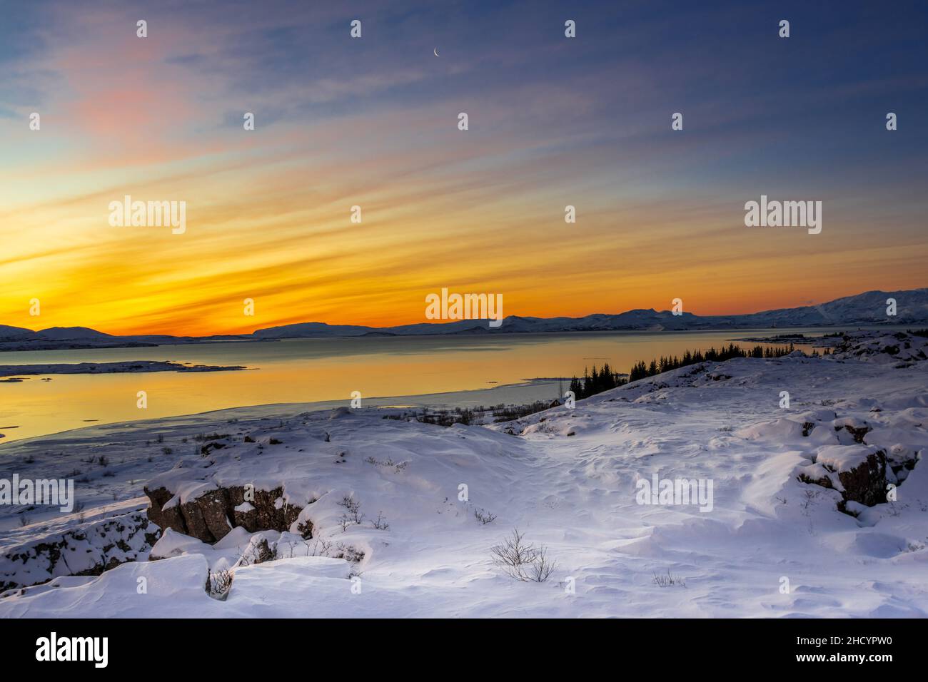 Crescent moon over Rift Valley Lake in Thingvellir National Park at ...