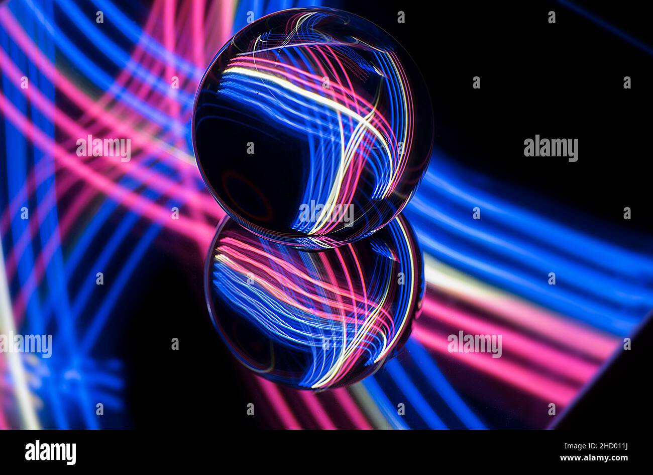 Glass ball reflecting colorful lights for wallpaper and background ...
