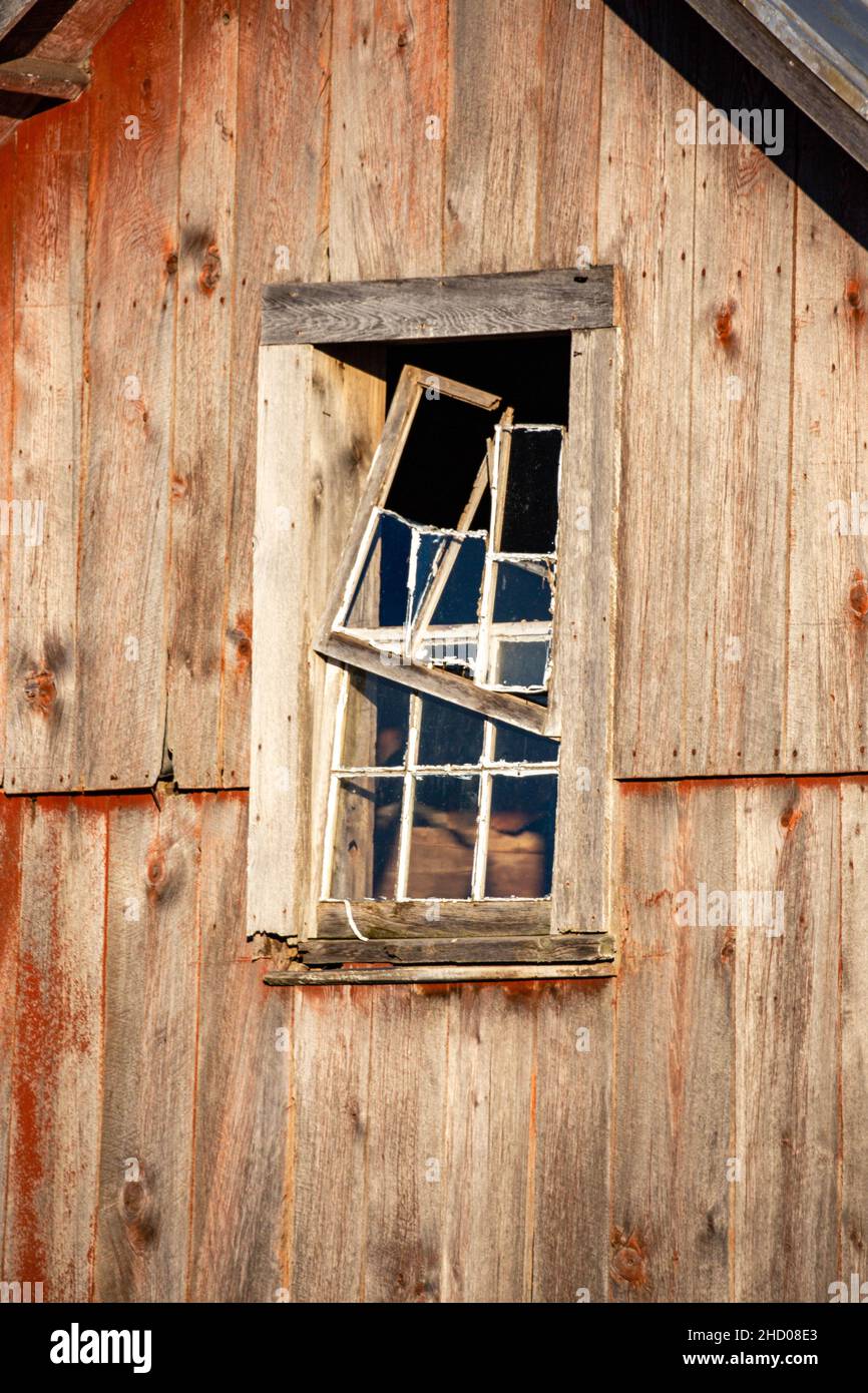 Rustic aged barn siding and broken window, vertical Stock Photo - Alamy