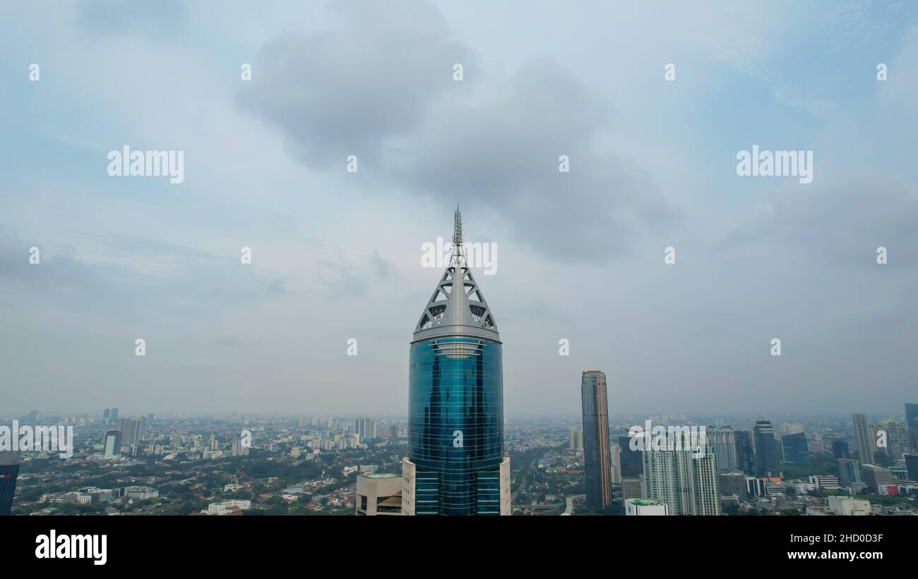 Aerial view of BNI 46 building in Jakarta and noise cloud with ...