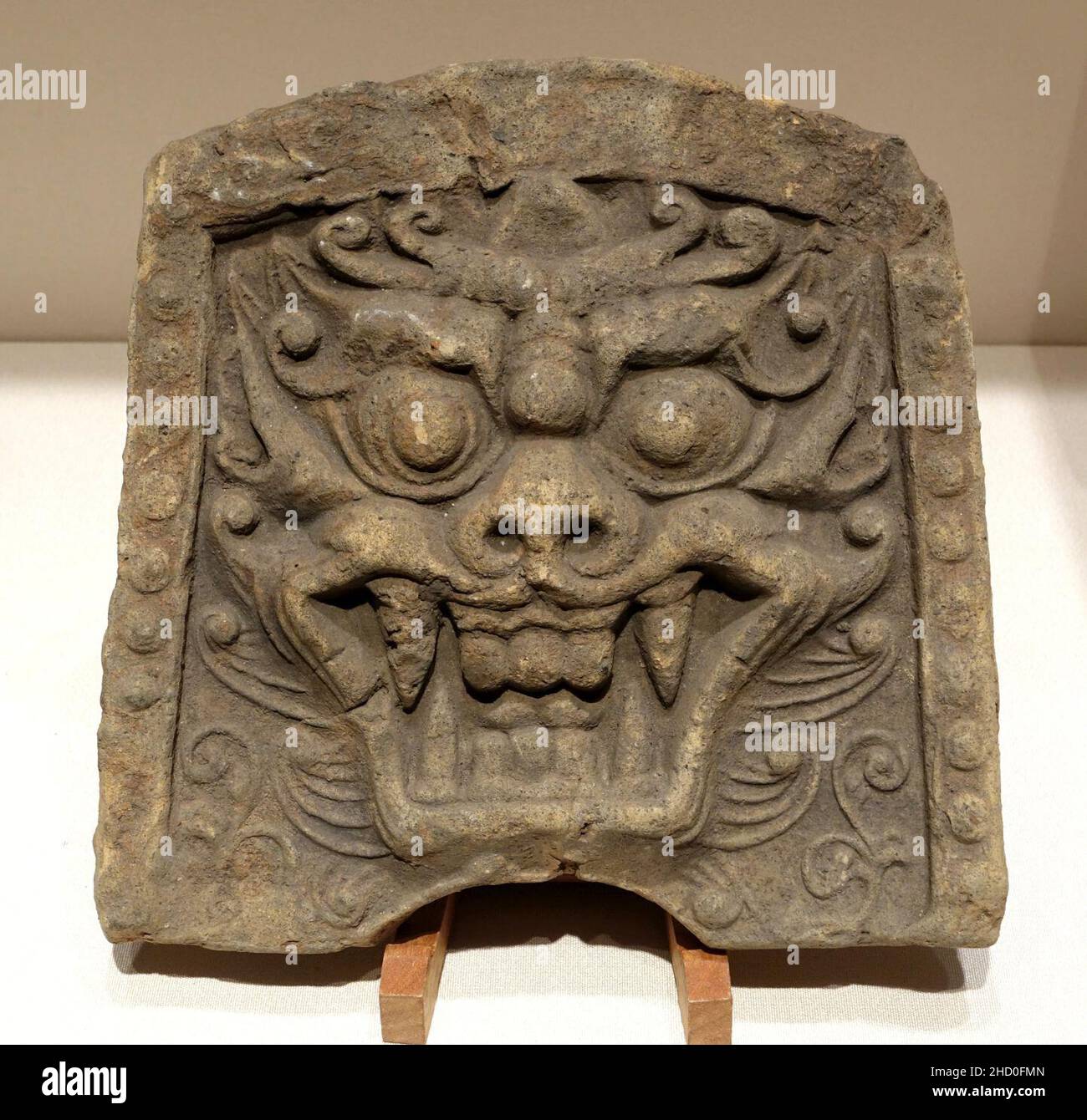 Ridge-end tile with demon face design, excavated from former temple ...