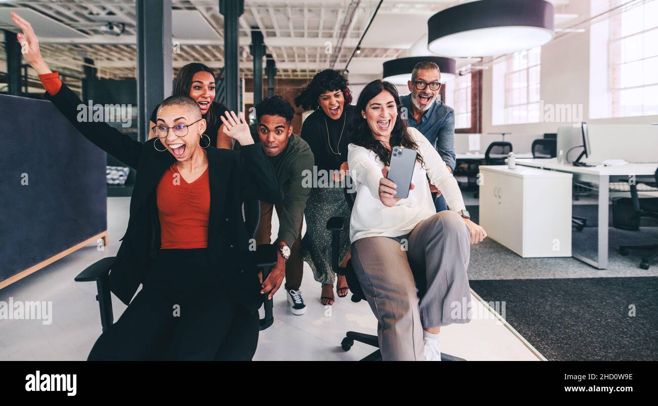 Capturing fun moments. Cheerful businesswoman taking a selfie with her ...