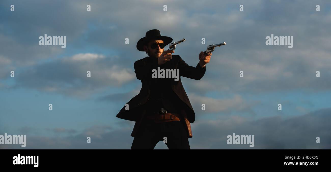 American cowboy shooting. Handsome brutal western guy. Sheriff with ...