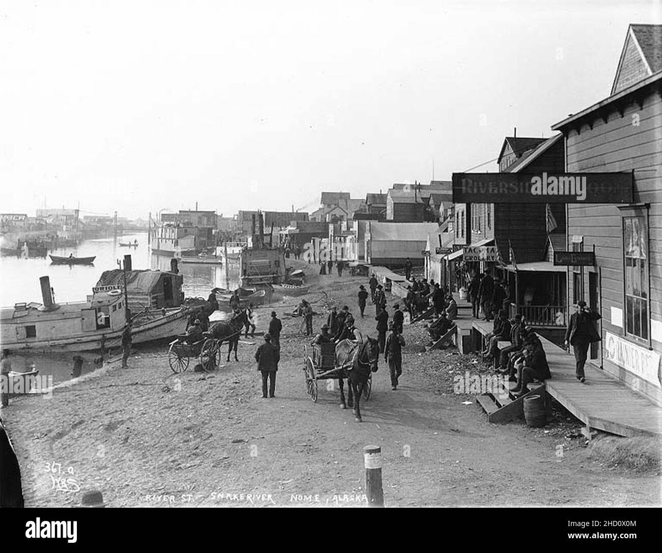 River Street along the Snake River, Nome, Alaska, ca 1900 Stock Photo ...