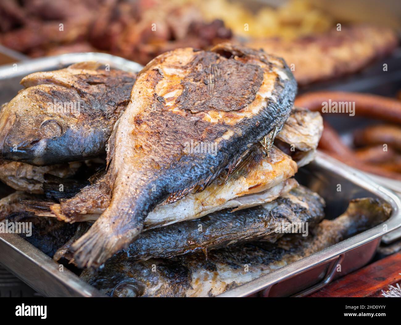 Roasted carp fish on a tray at e traditional street food festival in ...