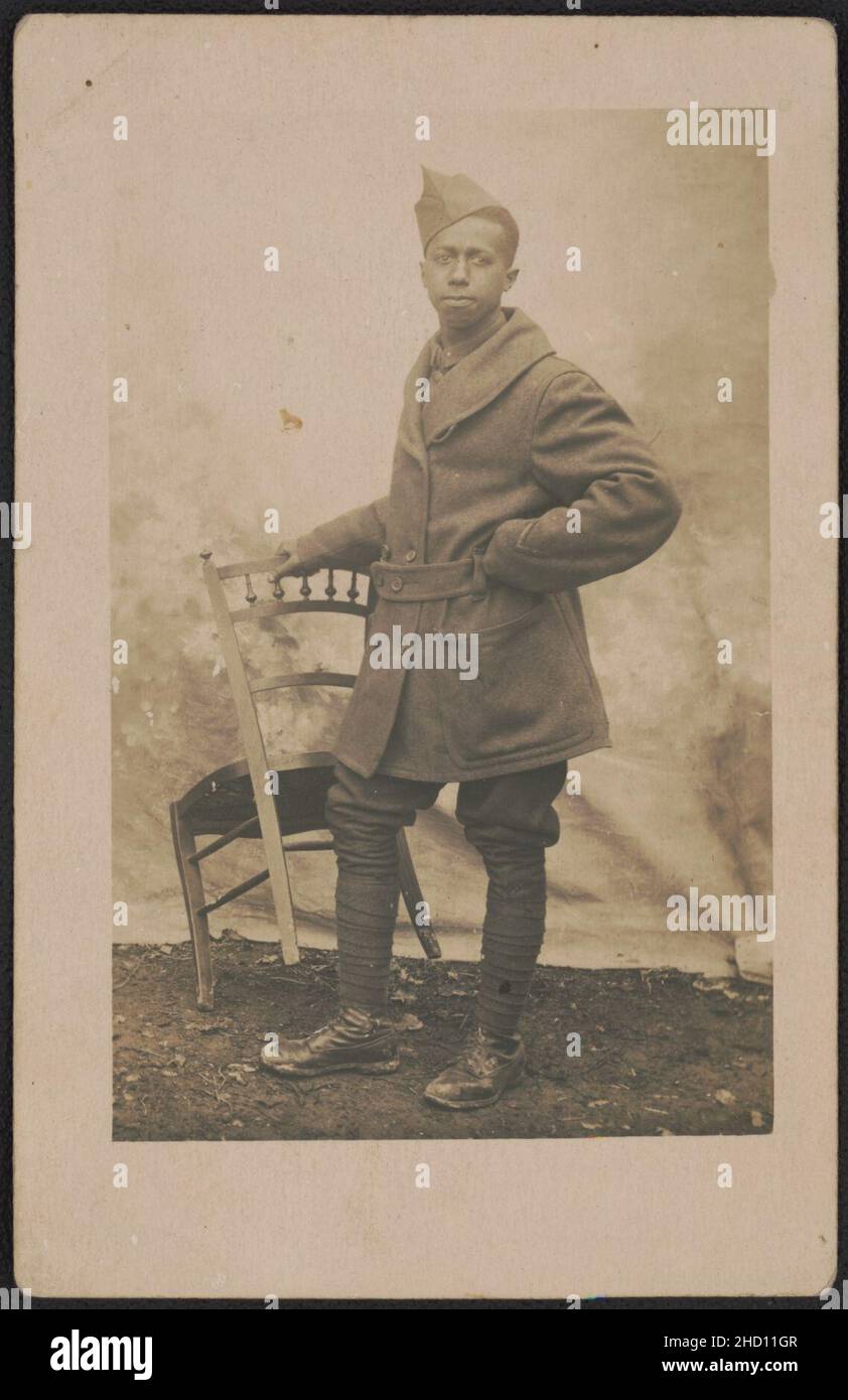 Robert Bennett Smith in uniform, overcoat, and overseas cap, holding a ...