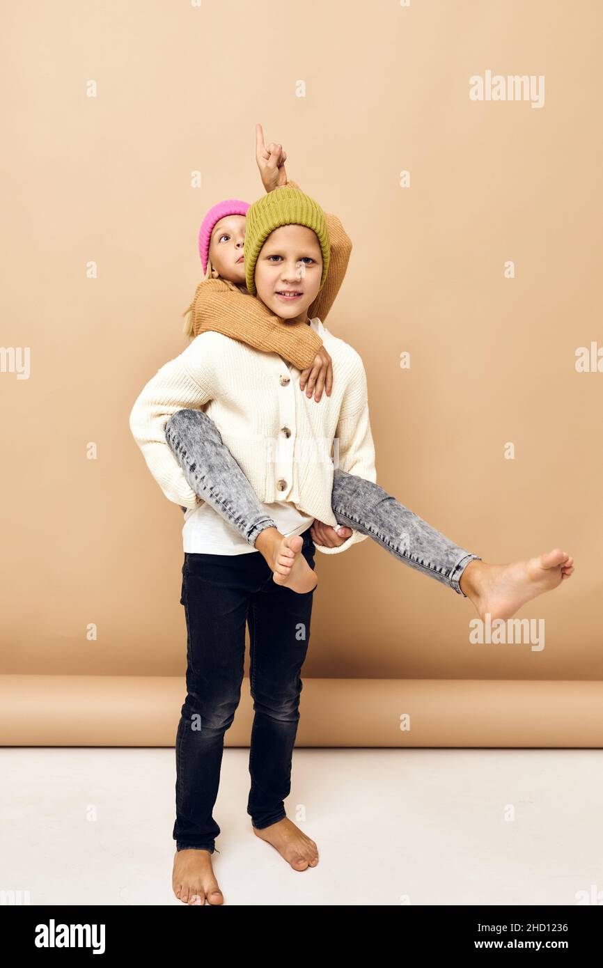 boy and girl friendship hug childhood grimace emotions beige background ...