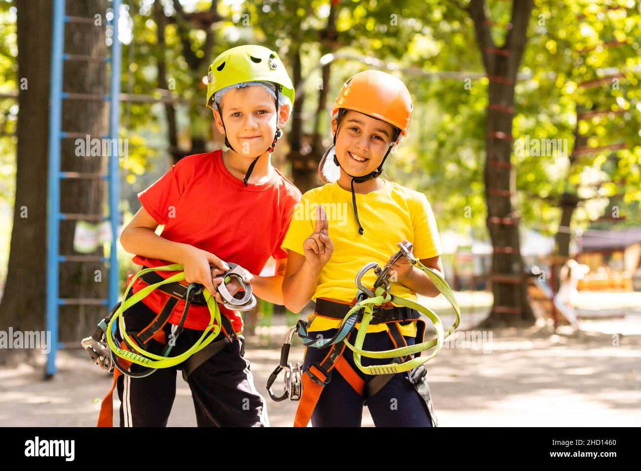 Happy child climbing in the trees. Rope park. Climber child. Early ...