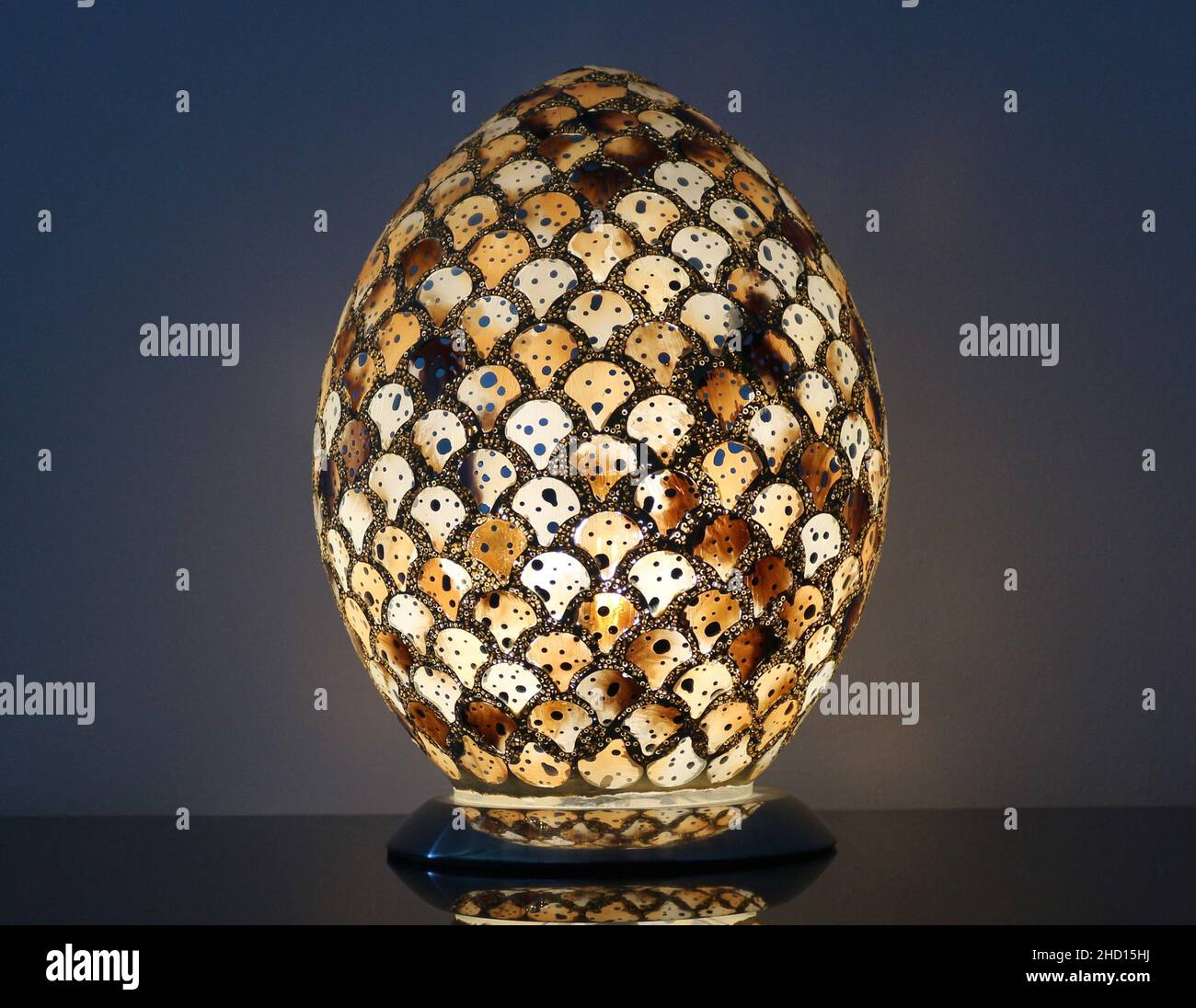 A beautiful oval shaped lamp with details against a white background in ...