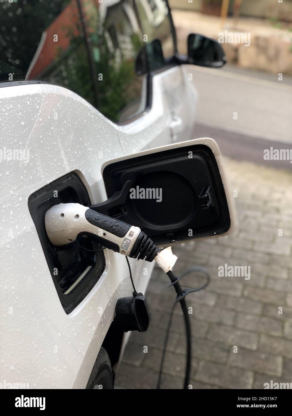 Photo of an electric car being charged with electricity Stock Photo - Alamy