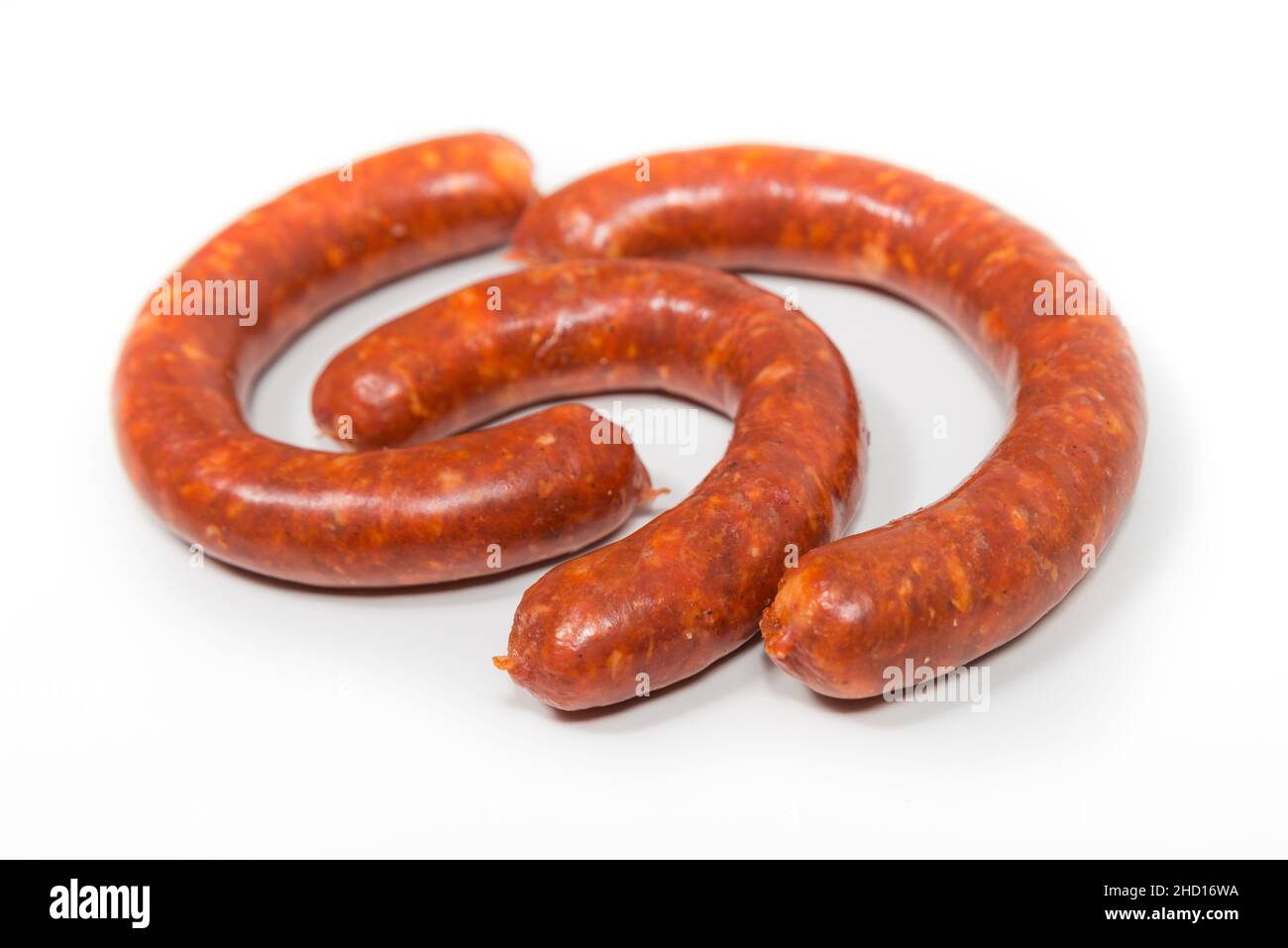 Three red chorizo crude sausages on a white background Stock Photo - Alamy