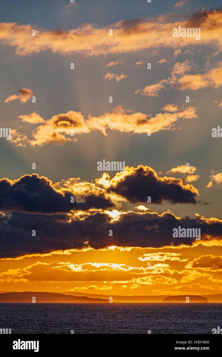 The setting sun lighting up some of the cloud cover Stock Photo - Alamy
