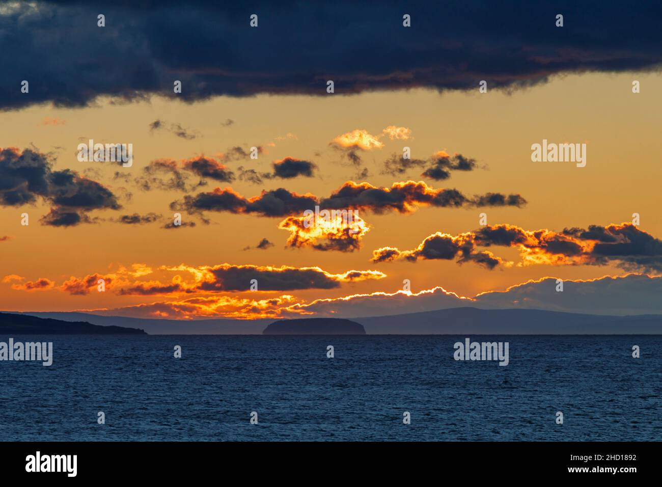 The setting sun lighting up some of the cloud cover Stock Photo - Alamy