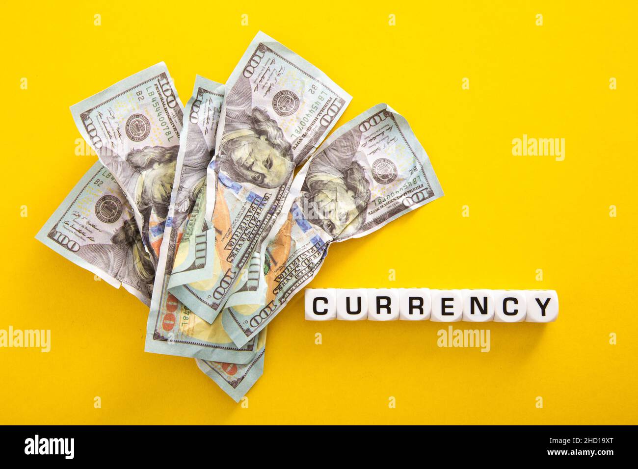 Money with Currency word on yellow background Stock Photo - Alamy