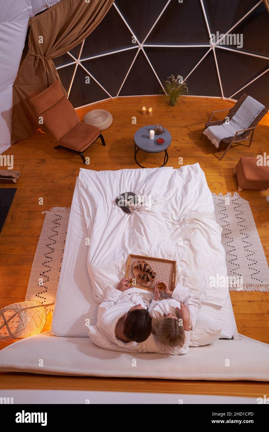 Couple having dinner in bed before sleep Stock Photo - Alamy