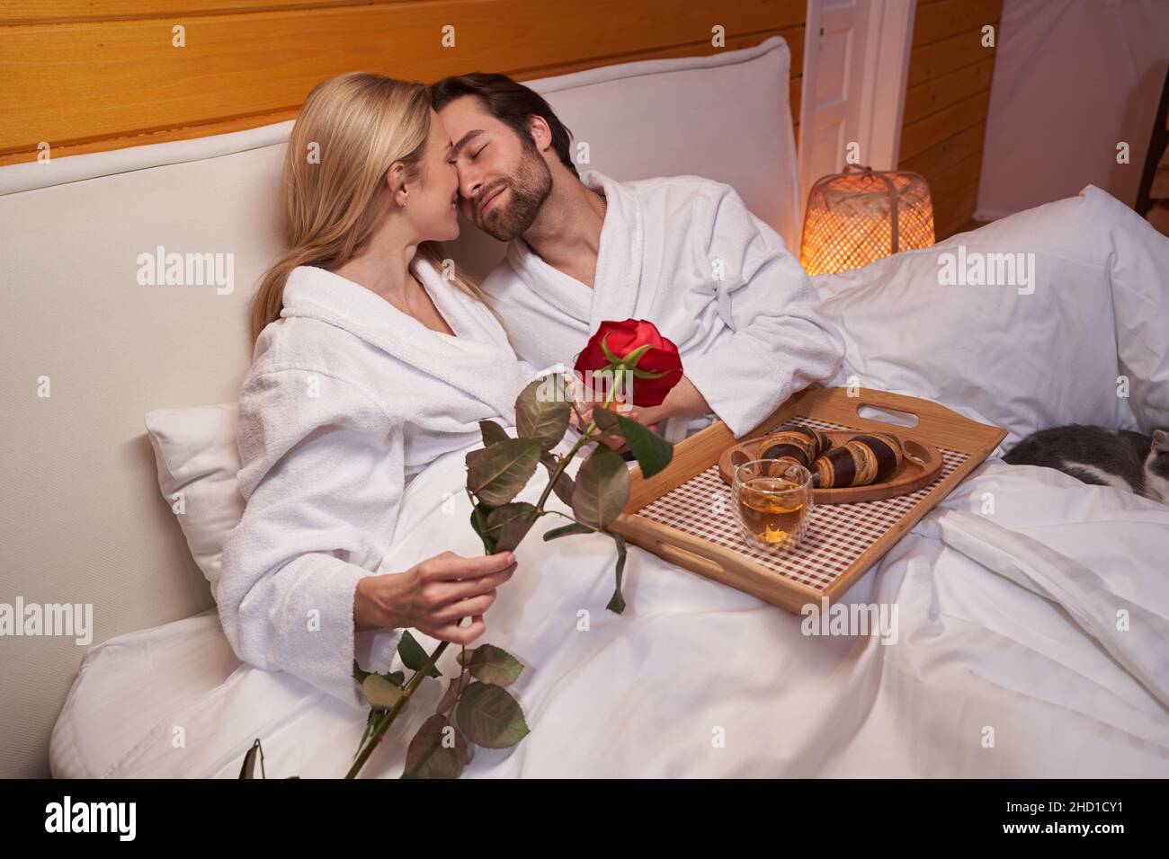 People in bed rubbing faces against each other Stock Photo - Alamy
