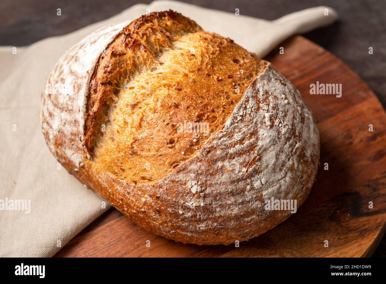 Sourdough bread on linen cloth on brown chopping board Stock Photo - Alamy