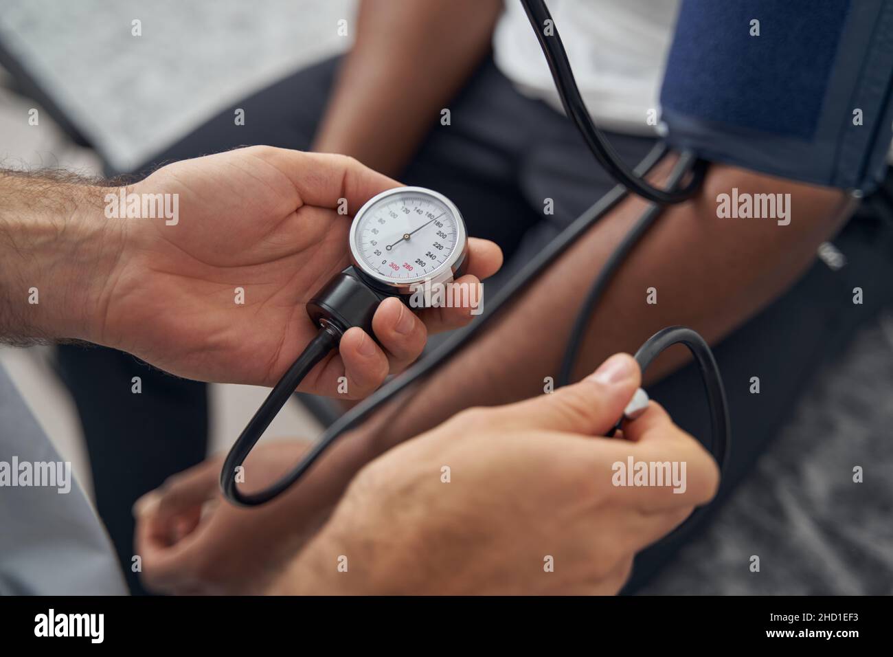 Physician performing medical examination of adult man Stock Photo - Alamy