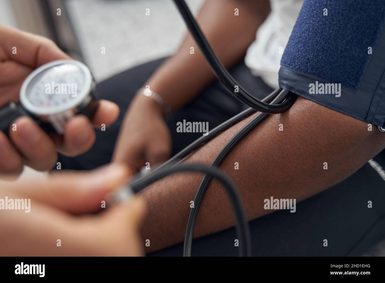 Experienced doctor using sphygmomanometer during medical exam Stock ...