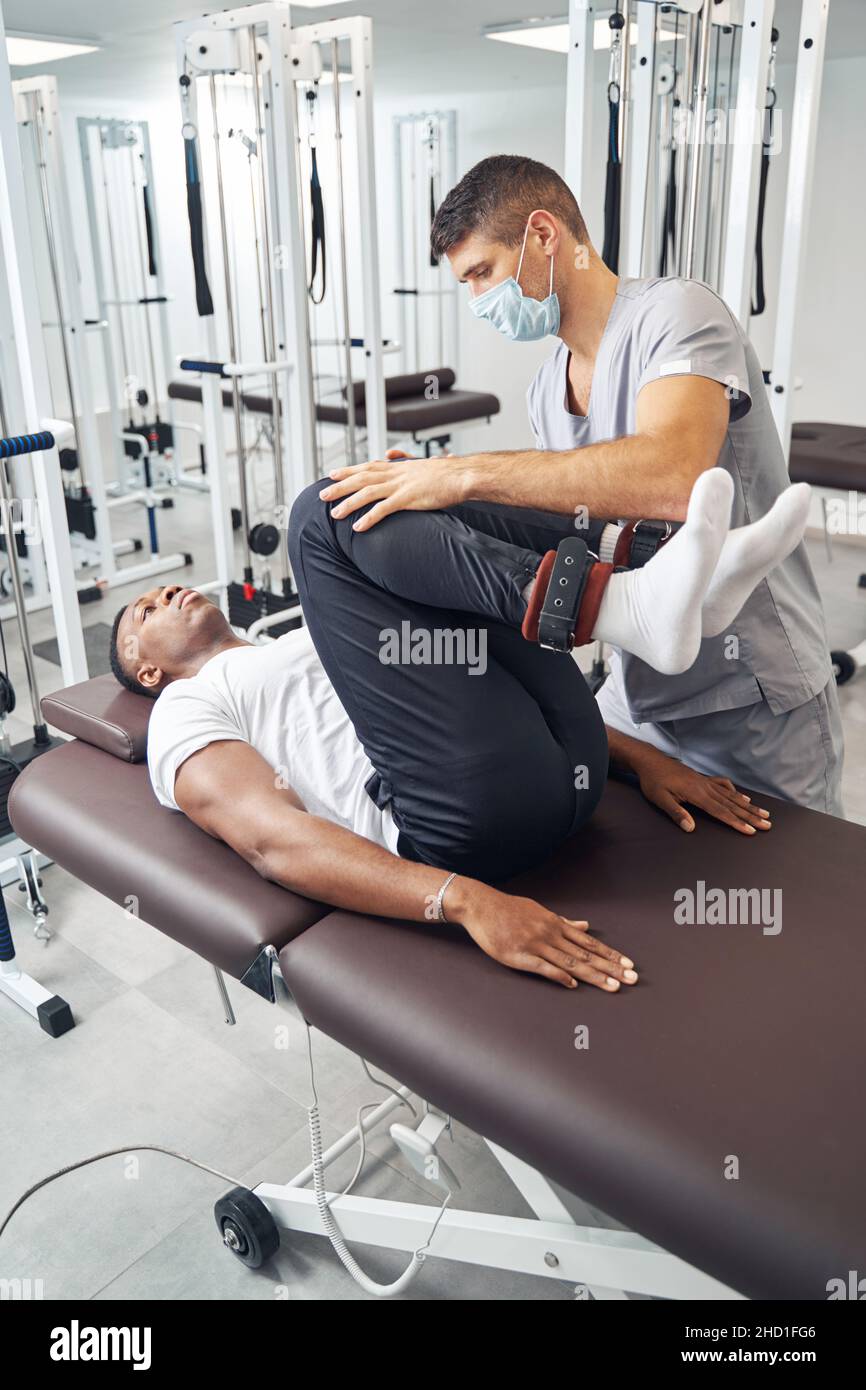 Young physiotherapist rehabilitating patient hi-res stock photography ...