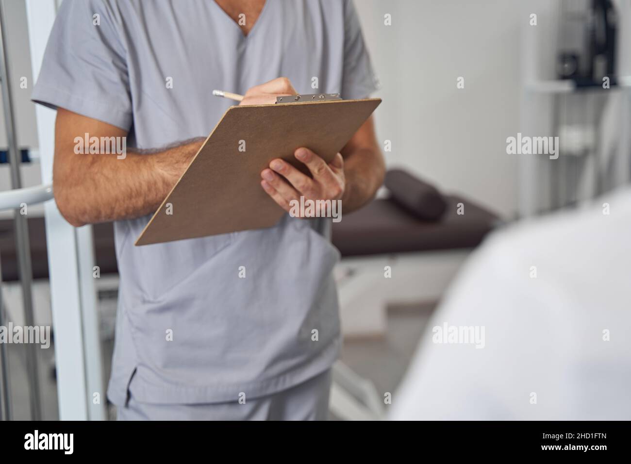 Doctor standing before his patient during medical consultation Stock ...