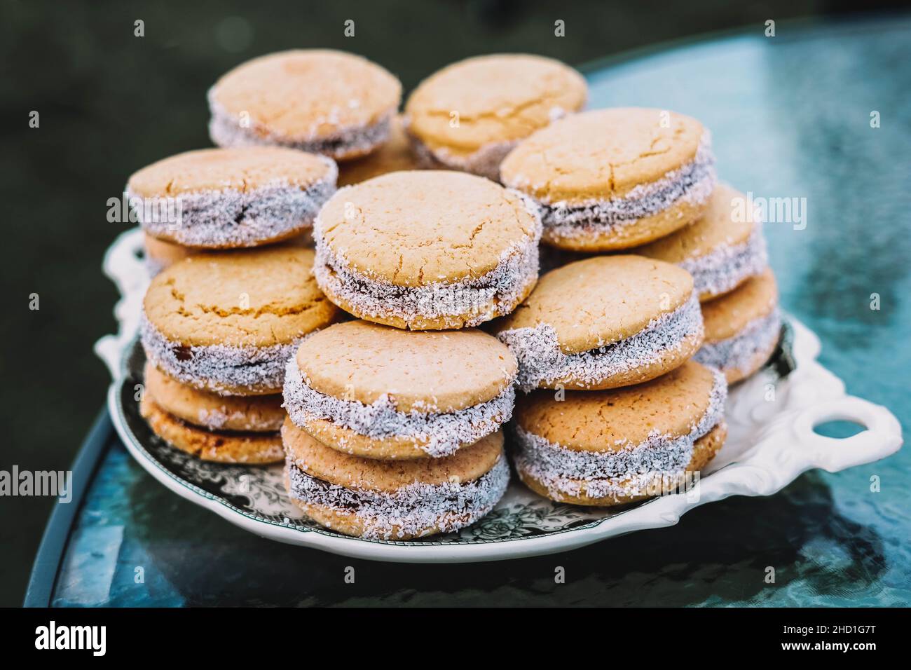 Plate full of cornstarch alfajores filled with dulce de leche. Typical ...
