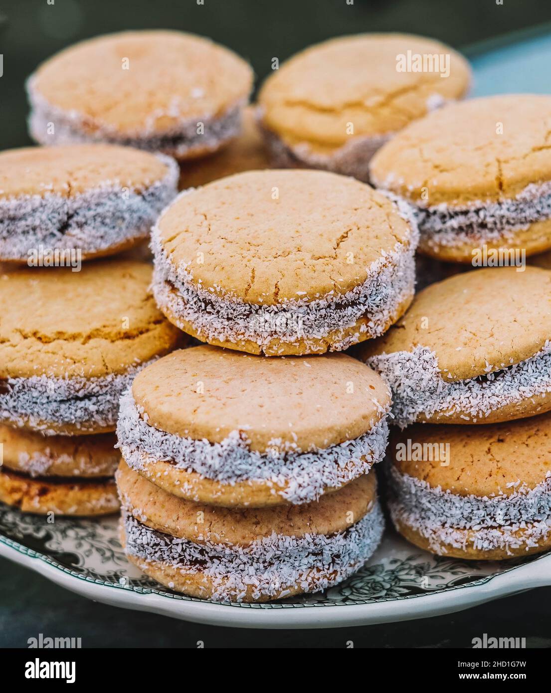 Plate full of cornstarch alfajores filled with dulce de leche. Typical ...