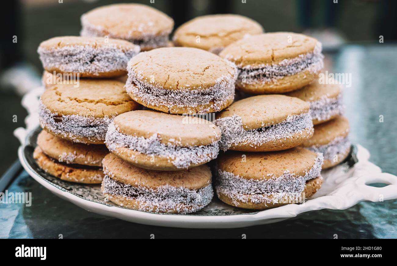 Plate full of cornstarch alfajores filled with dulce de leche. Typical ...