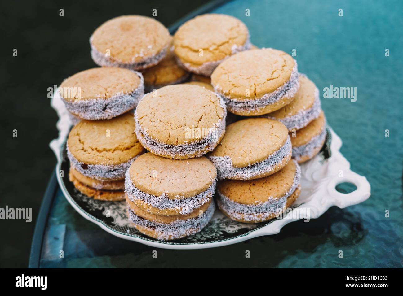 Plate full of cornstarch alfajores filled with dulce de leche. Typical ...