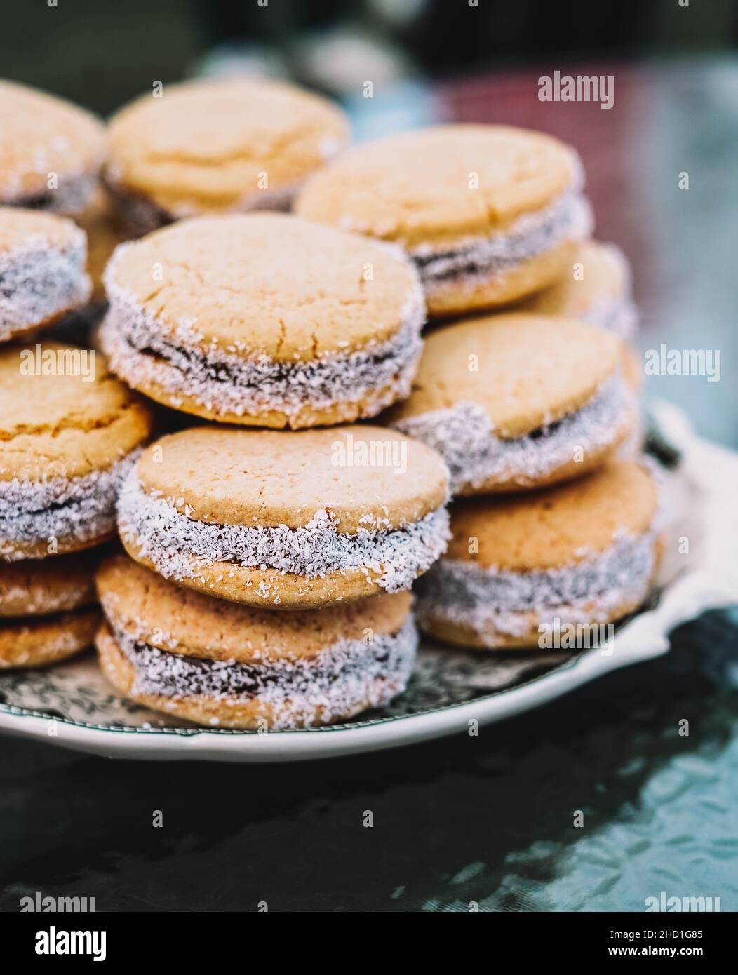 Plate full of cornstarch alfajores filled with dulce de leche. Typical ...