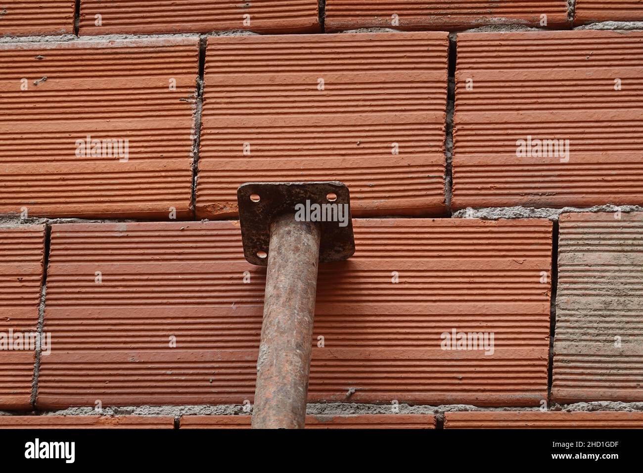 Wooden pole against a brick wall Stock Photo - Alamy