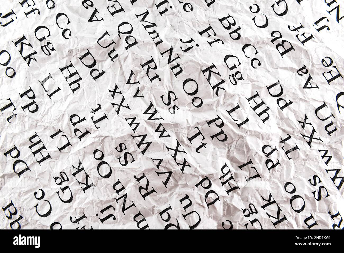 Background from crumpled white paper with alphabet close-up. Pleated ...