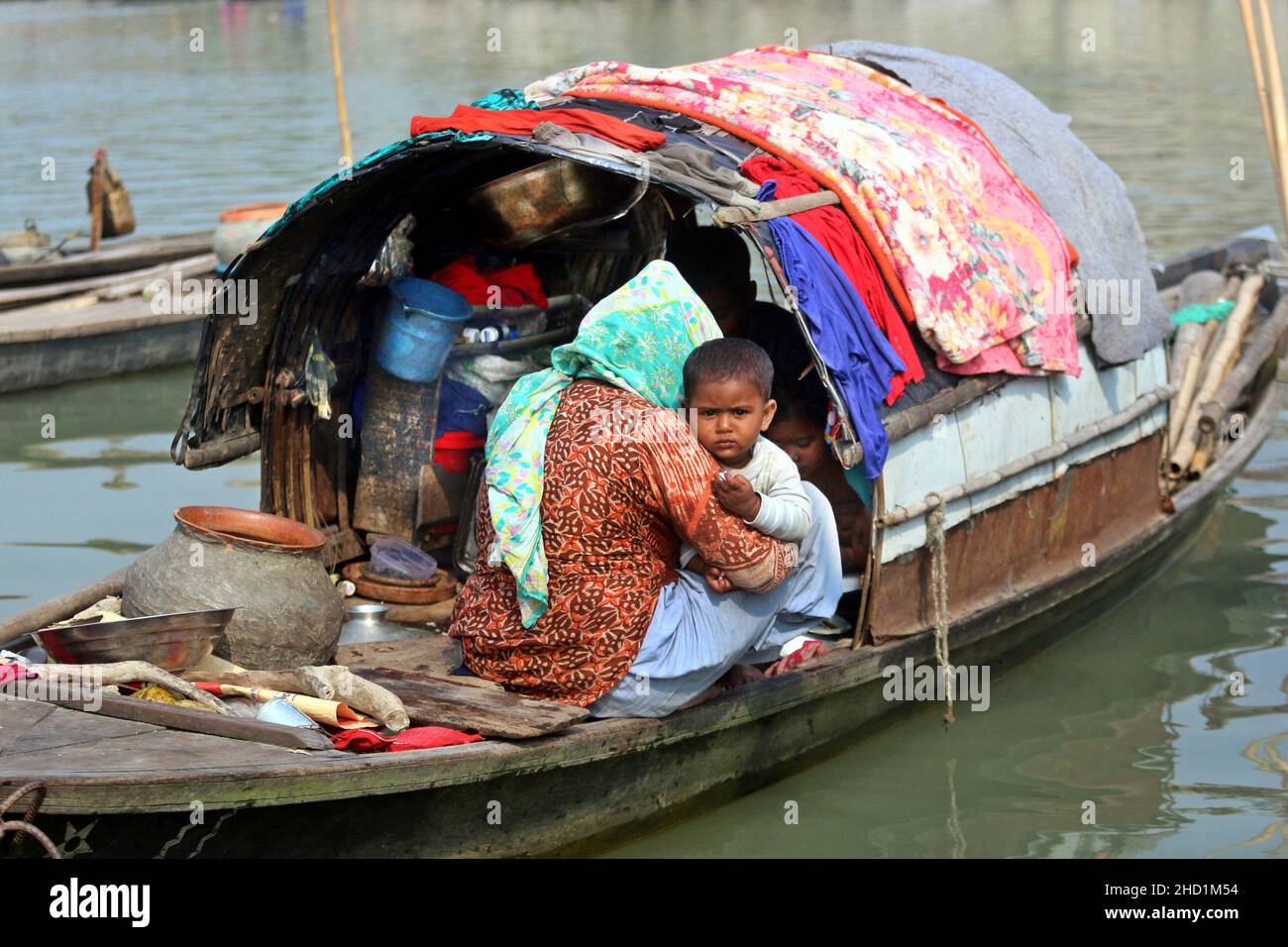 Hundreds of Gypsy families live in small wooden boats on the bank of ...