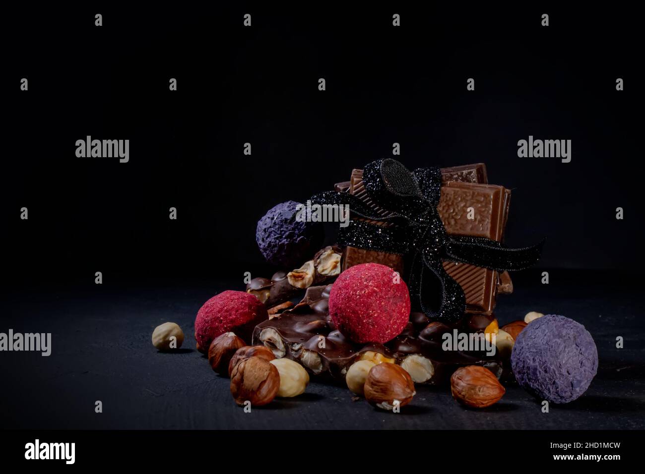 Chocolate bar, crushed pieces of dark chocolate and nuts. Praline ...