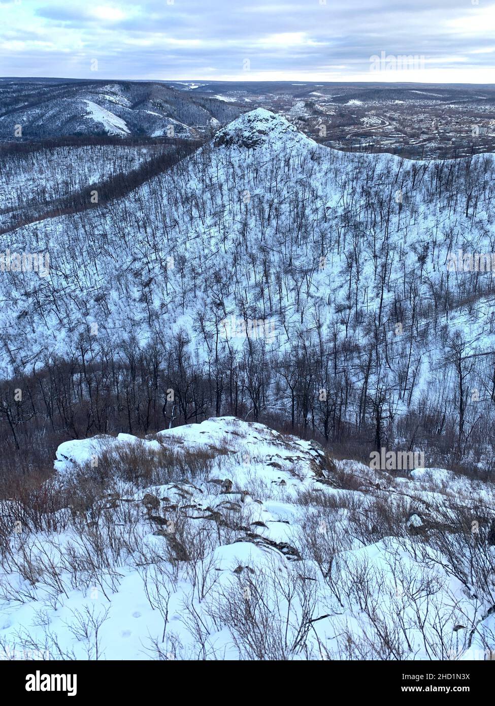 Winter landscape with hills and distant village Stock Photo - Alamy