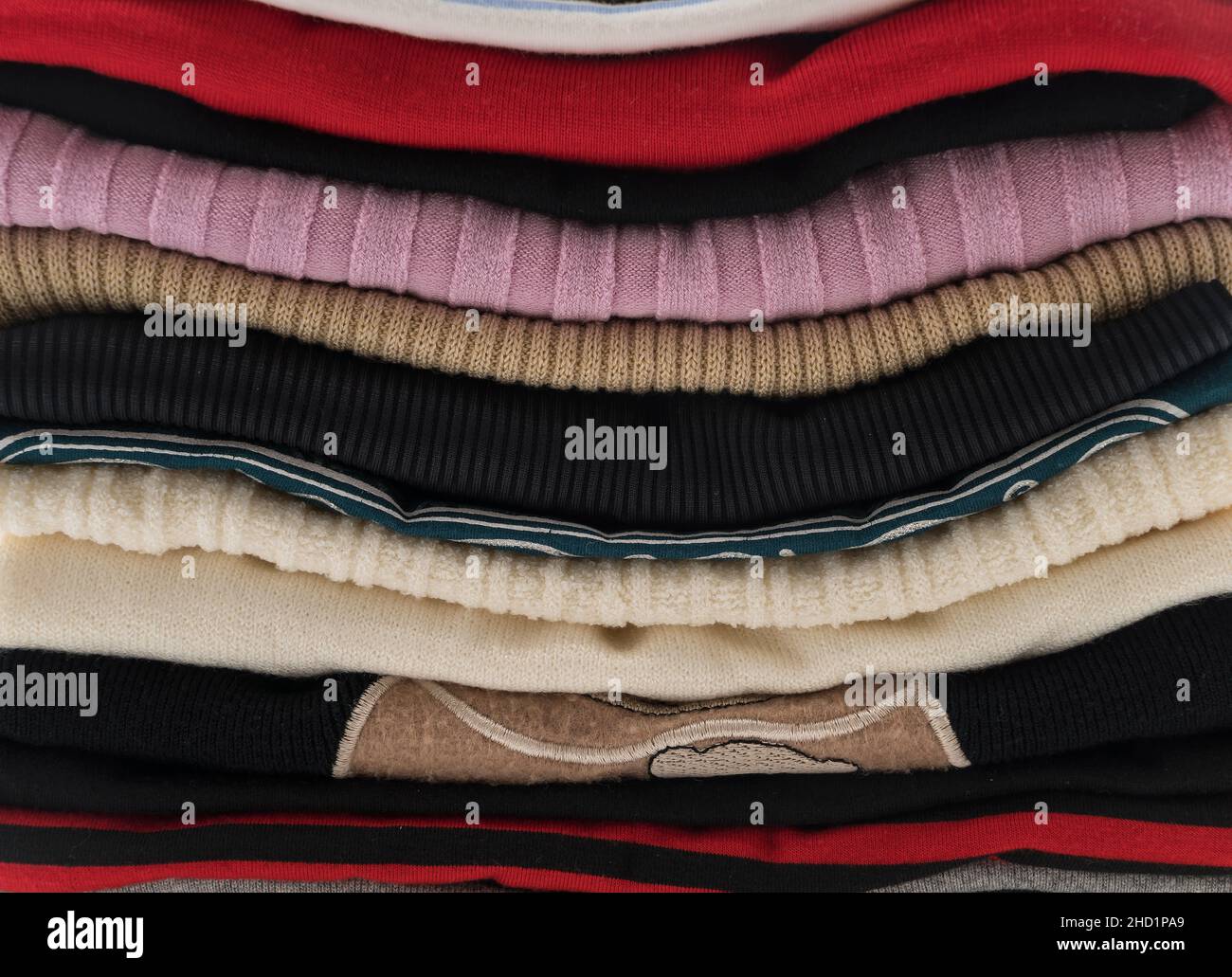 stacks of clothing on white background Stock Photo - Alamy