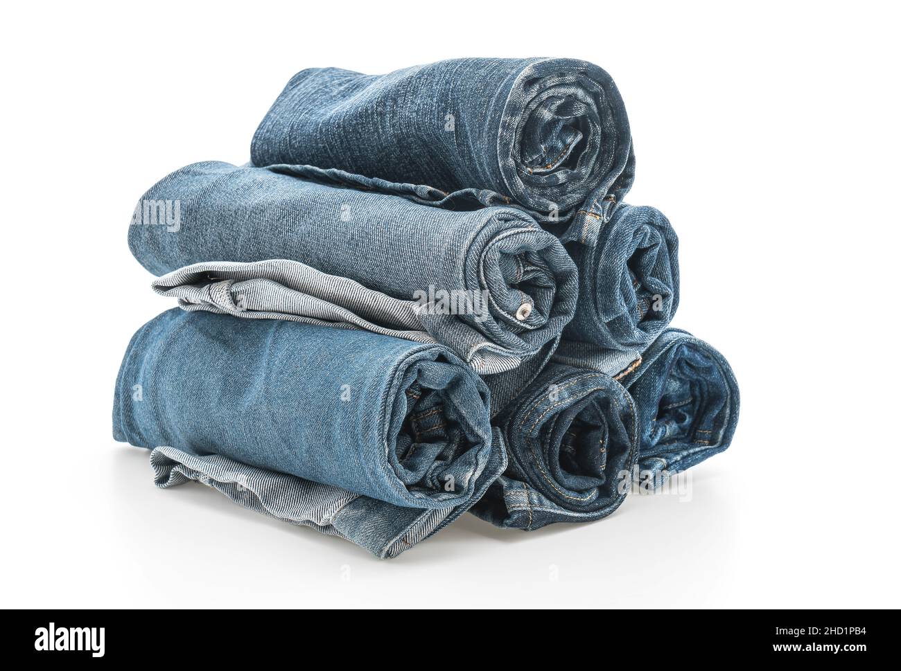 stacks of jeans clothing on white background Stock Photo - Alamy